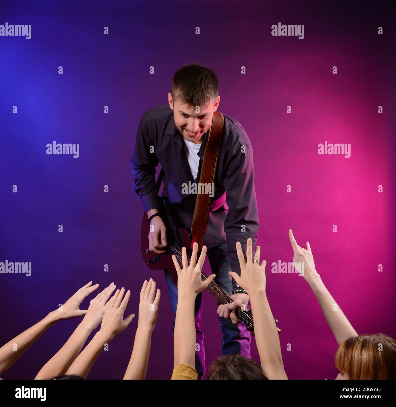 Guitarist singing on stage at a rock concert for his adoring fans Stock ...