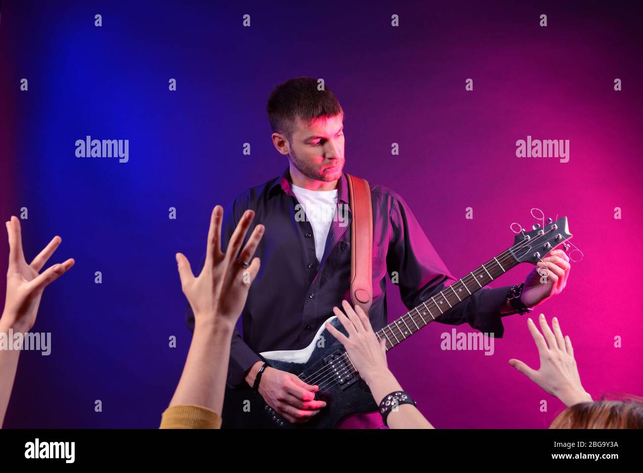 Guitarist singing on stage at a rock concert for his adoring fans Stock ...