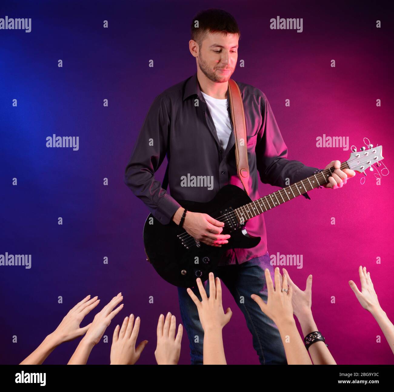 Guitarist singing on stage at a rock concert for his adoring fans Stock ...