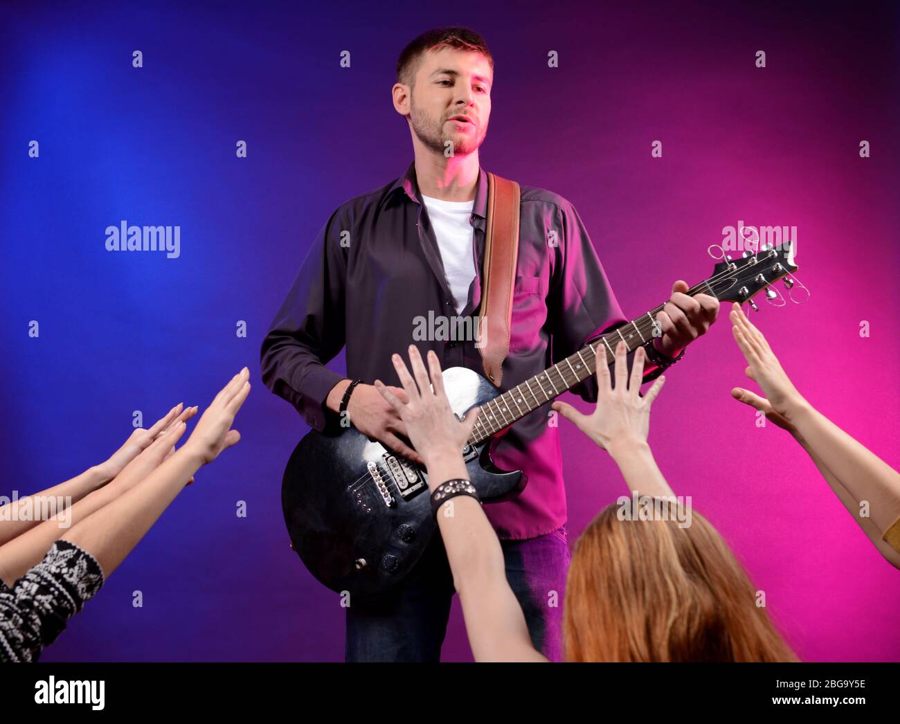 Guitarist singing on stage at a rock concert for his adoring fans Stock ...