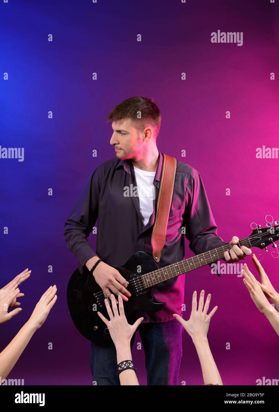 Guitarist singing on stage at a rock concert for his adoring fans Stock ...