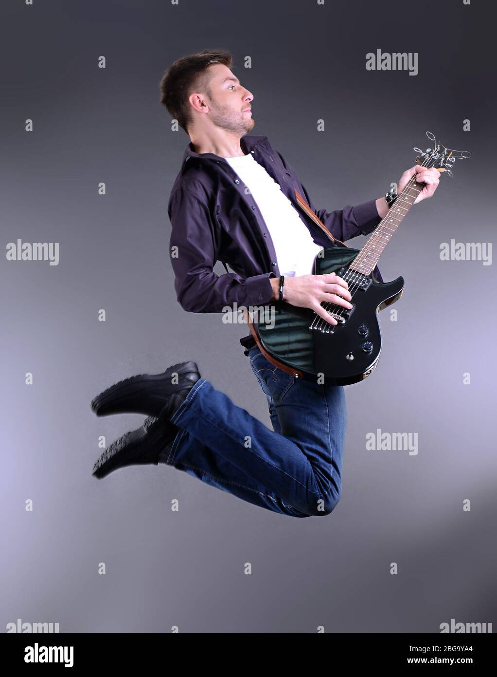 Young musician playing guitar, isolated on white Stock Photo - Alamy