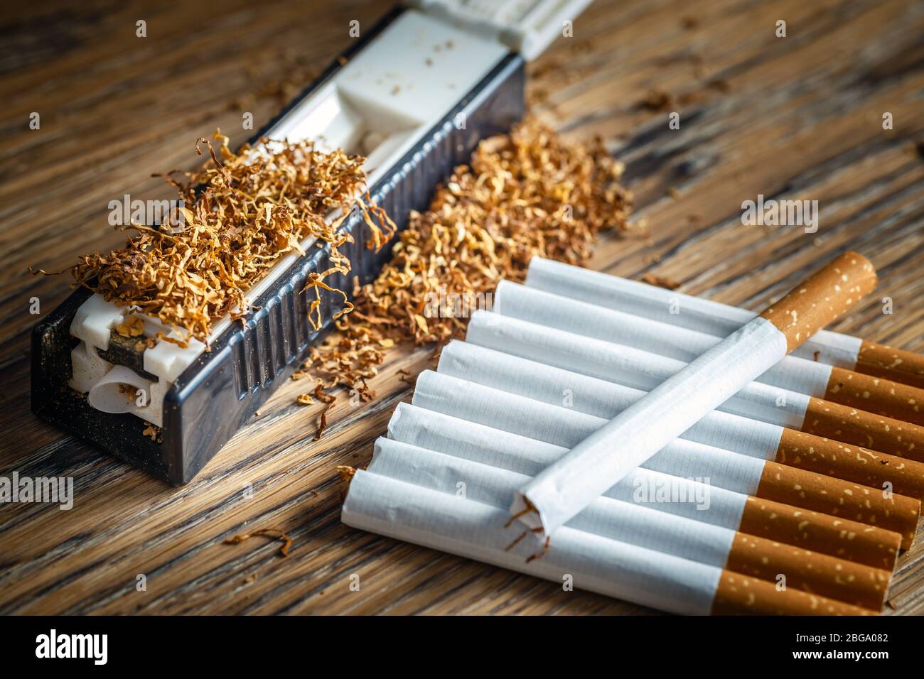 hand-made cigarettes at home using a manual machine Stock Photo - Alamy