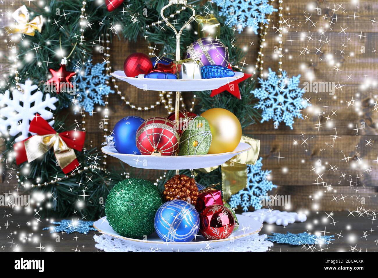 Christmas decorations on dessert stand, on color wooden background ...