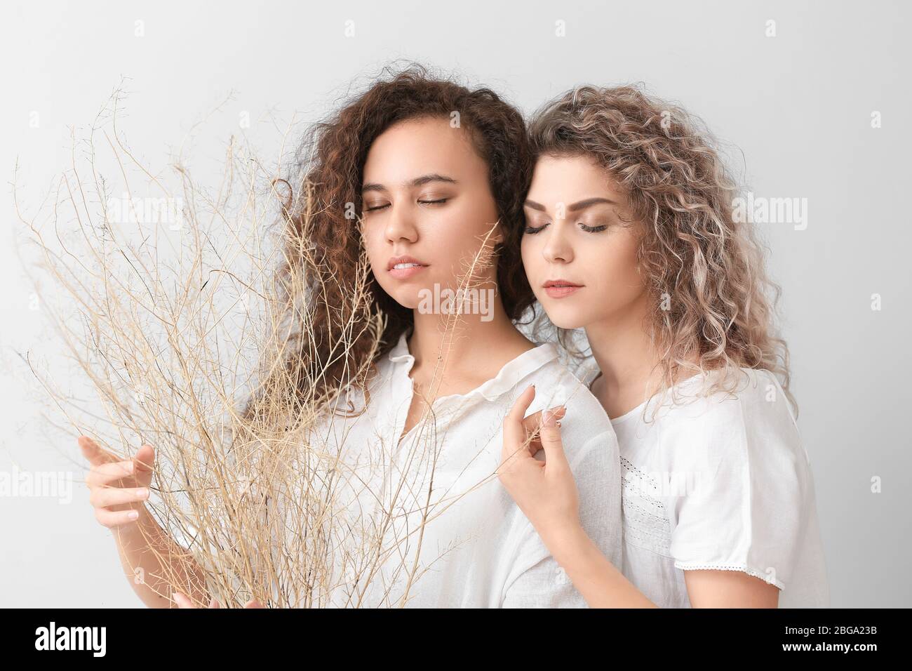 Beautiful young women on light background Stock Photo - Alamy