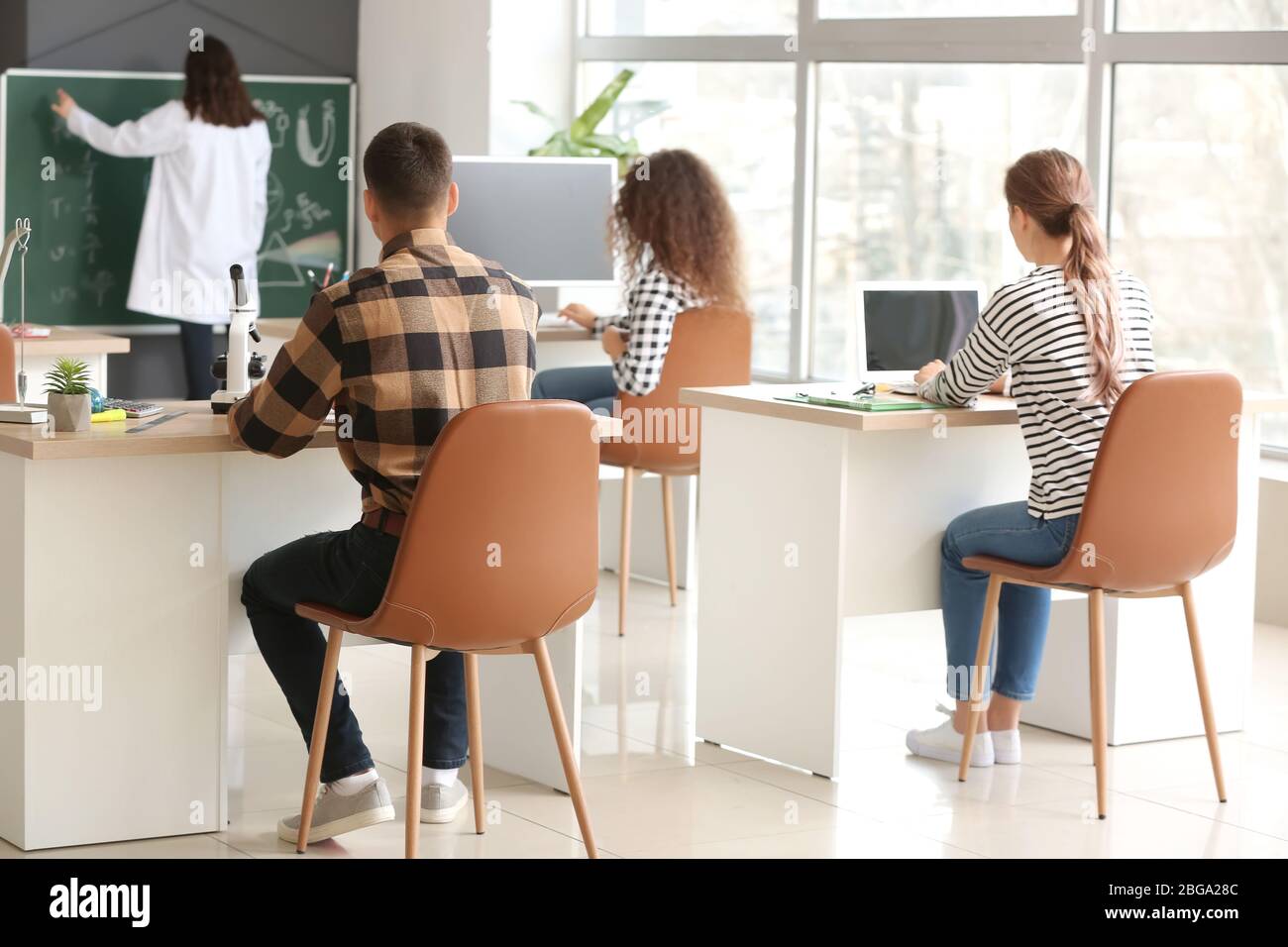 Teacher conducting physics lesson in classroom Stock Photo - Alamy