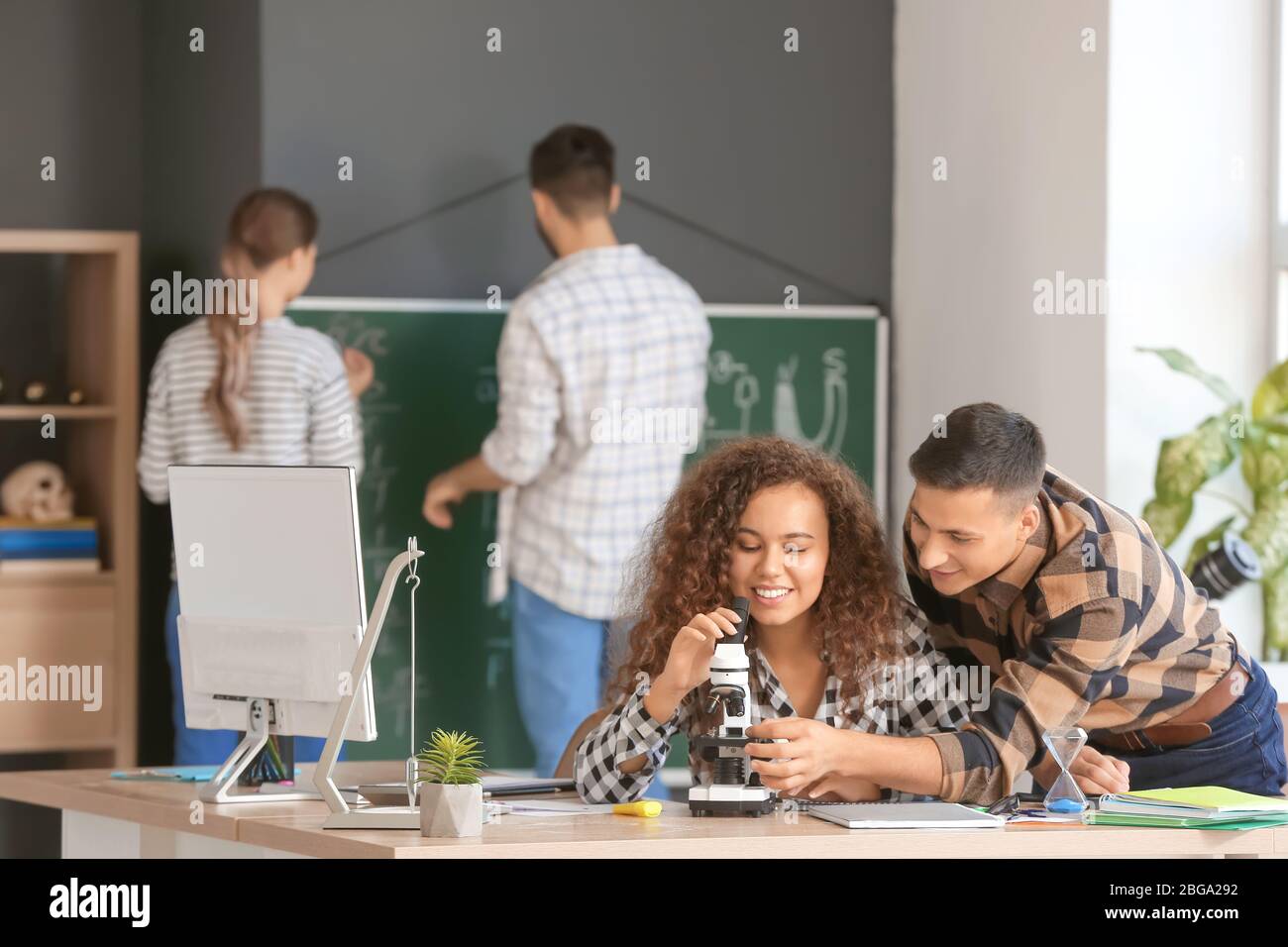 Young people at lesson in classroom Stock Photo - Alamy