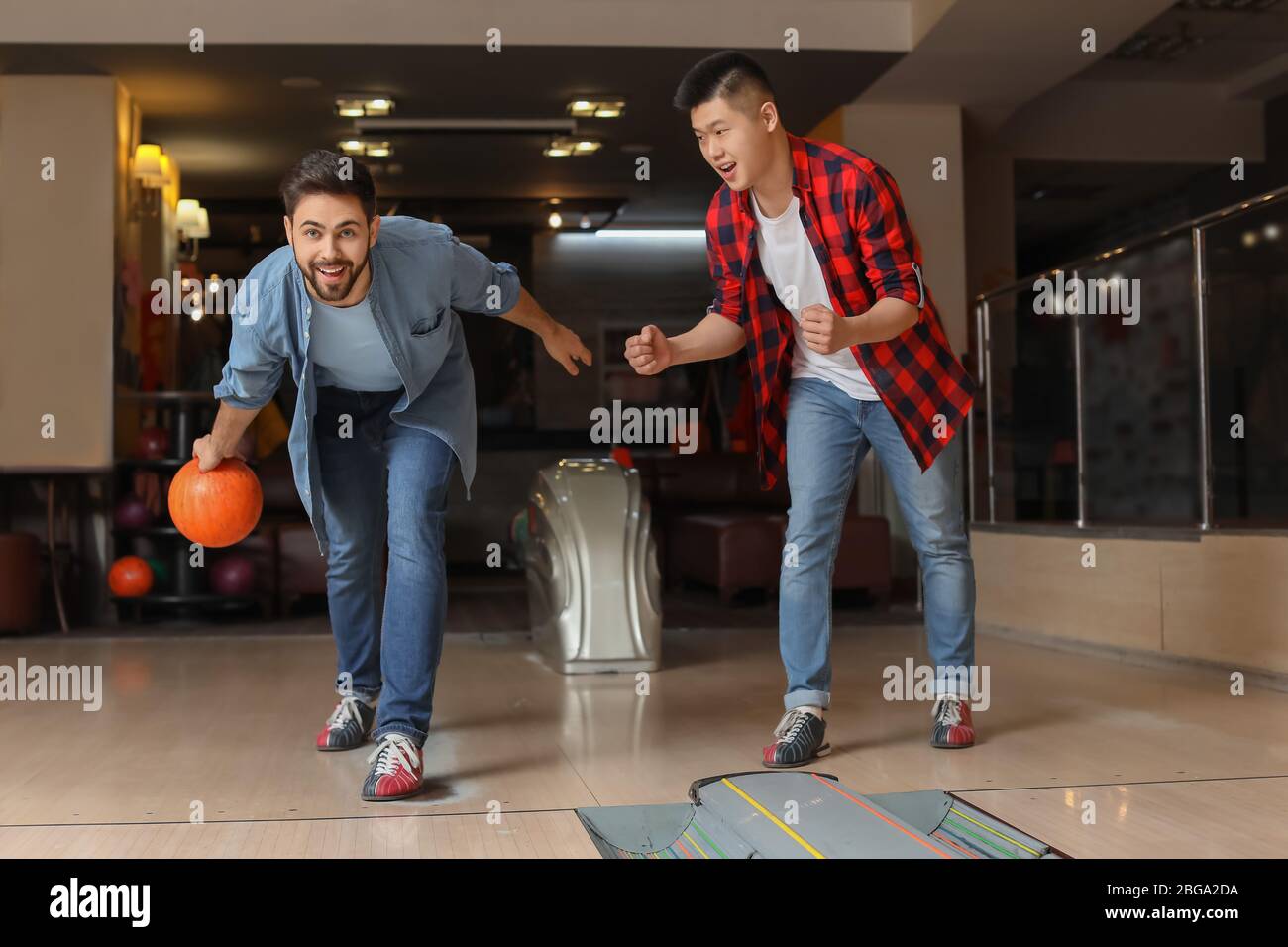 Friends playing bowling in club Stock Photo - Alamy