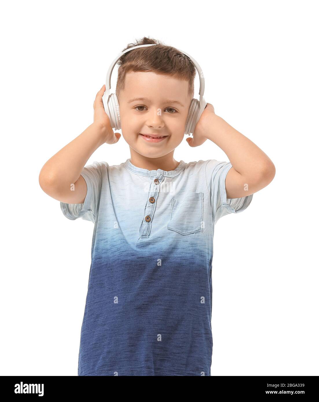 Cute little boy listening to music on white background Stock Photo - Alamy