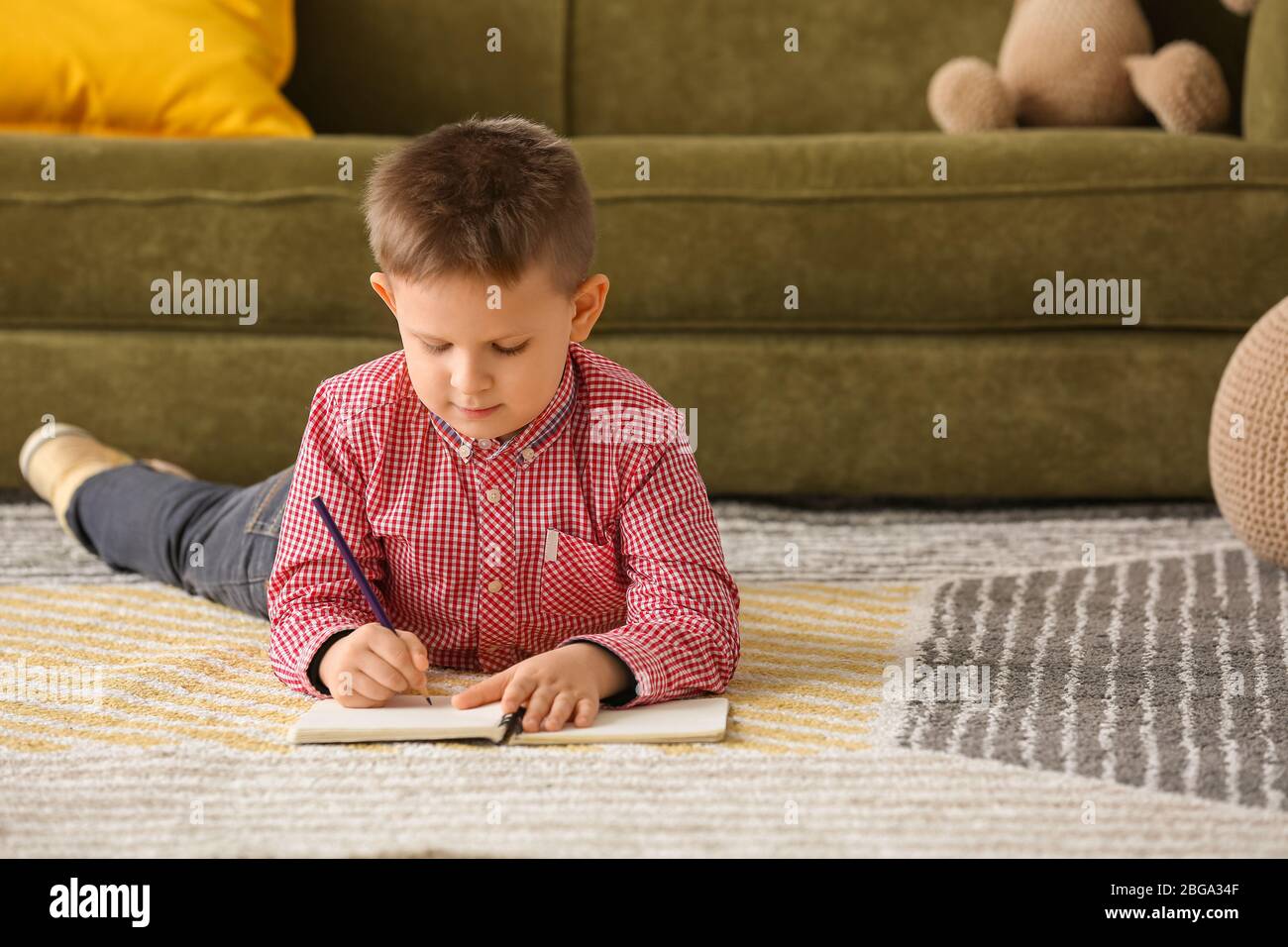 Cute little boy with notebook at home Stock Photo - Alamy