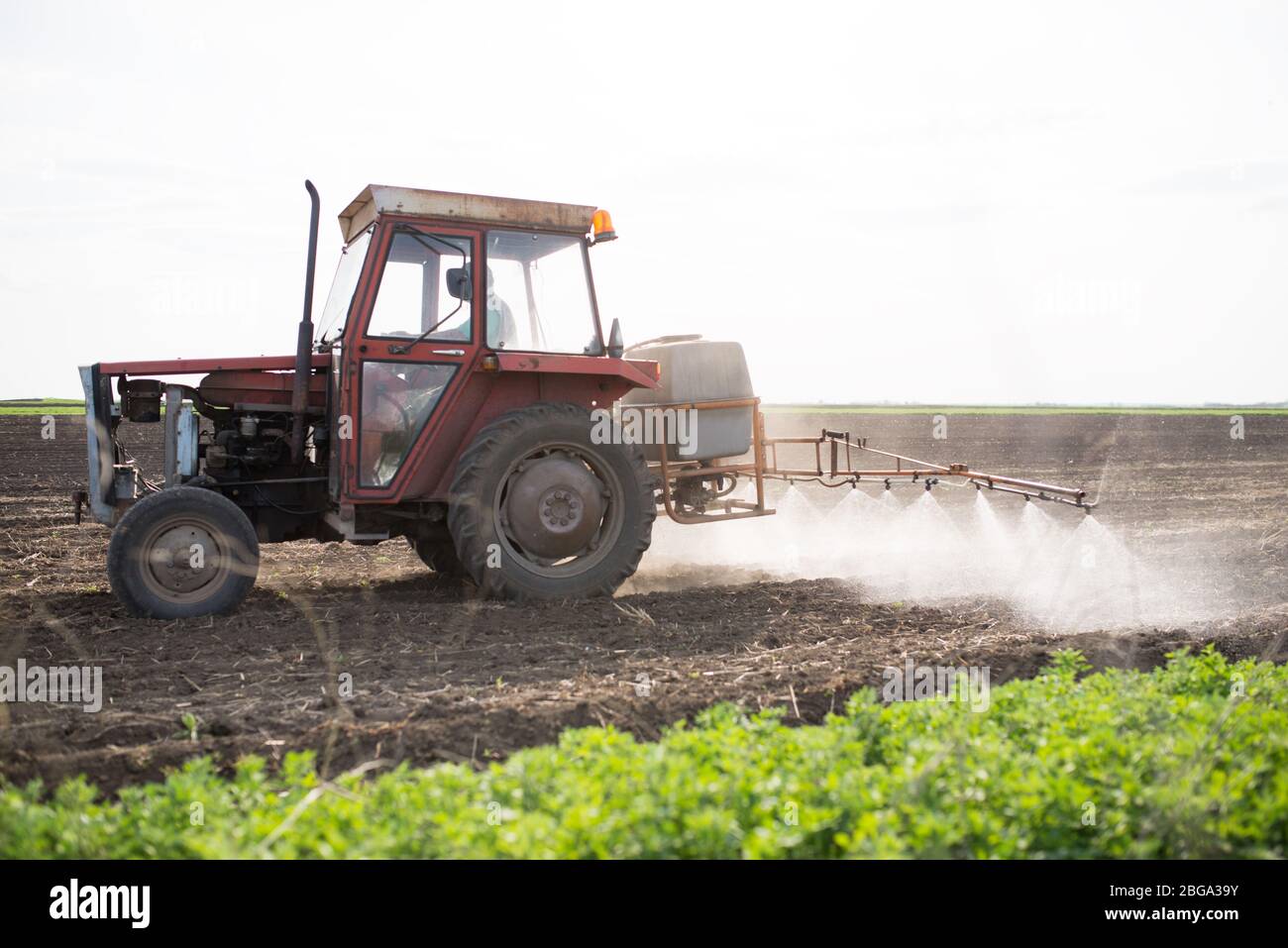 Agricultural sprayers, spray chemicals on field. spraying pesticides on ...
