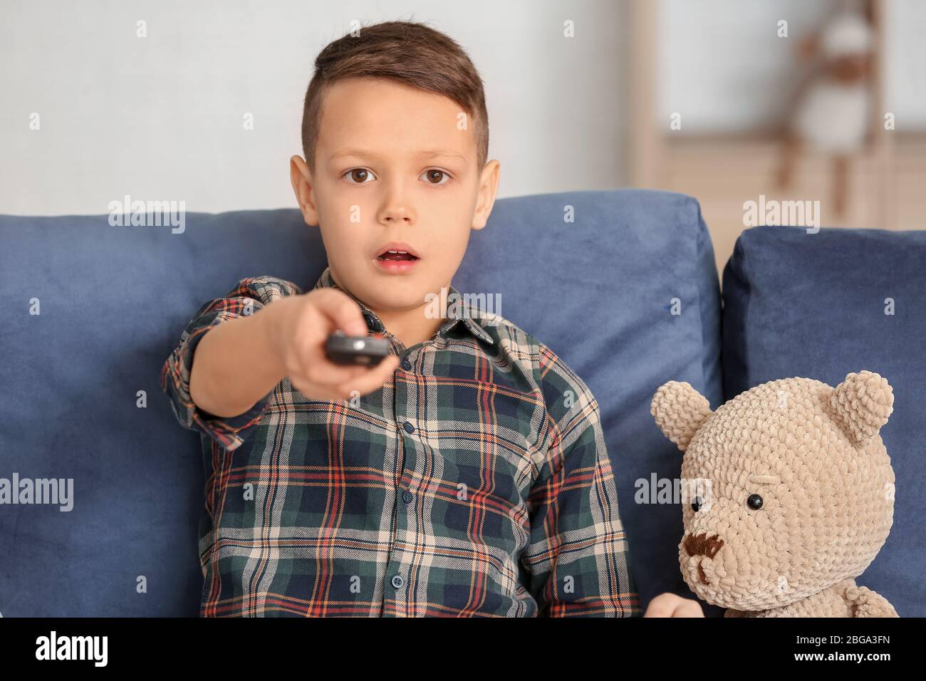 Cute little boy watching TV at home Stock Photo - Alamy