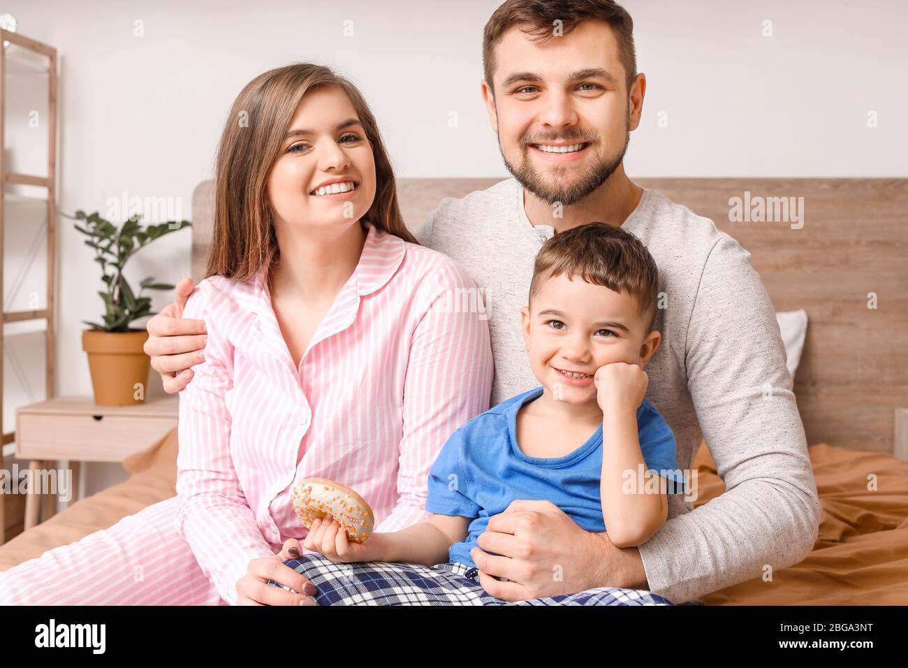Portrait of happy family in bedroom Stock Photo - Alamy