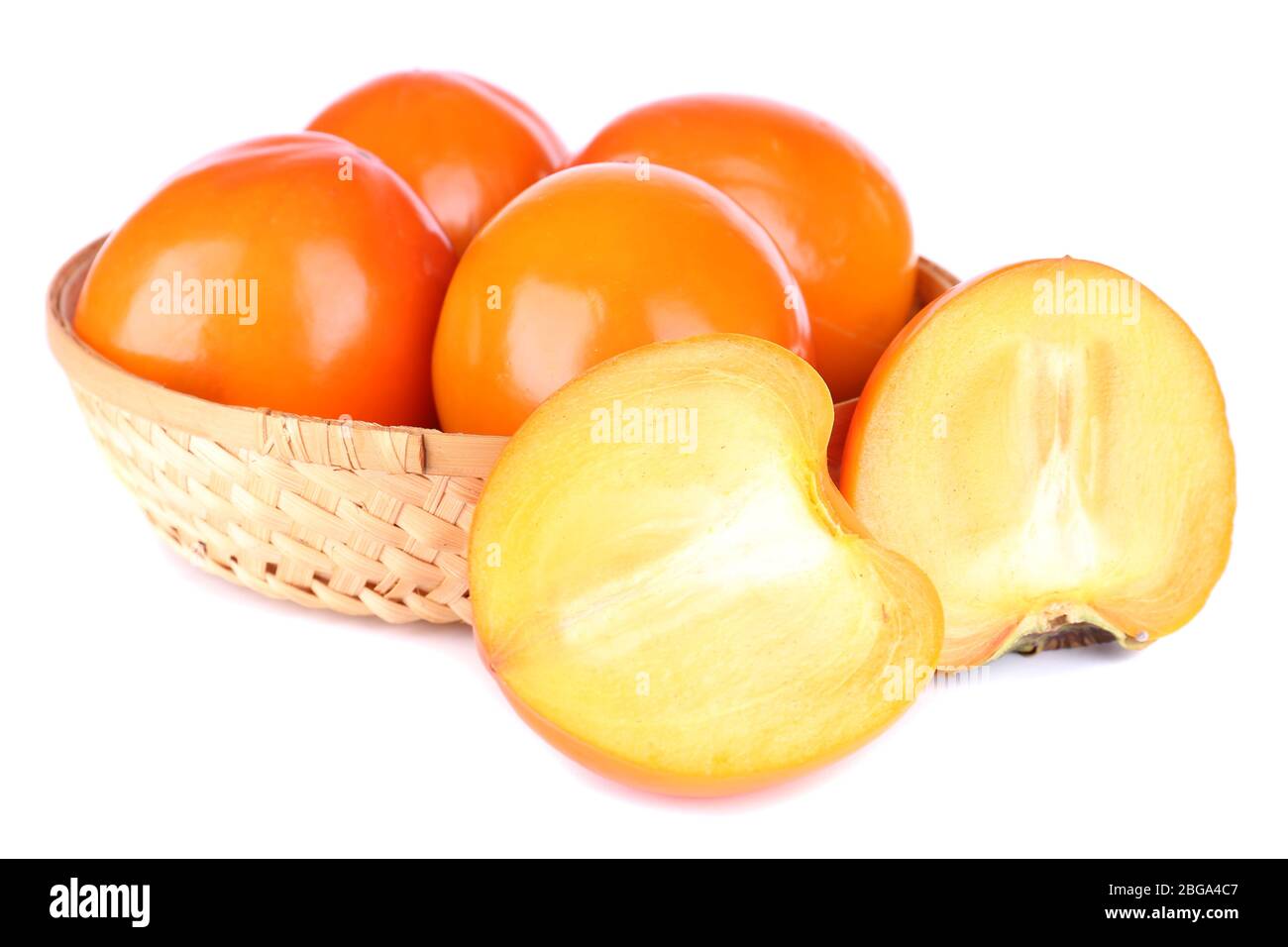 Ripe persimmons in wicker basket isolated on white Stock Photo - Alamy