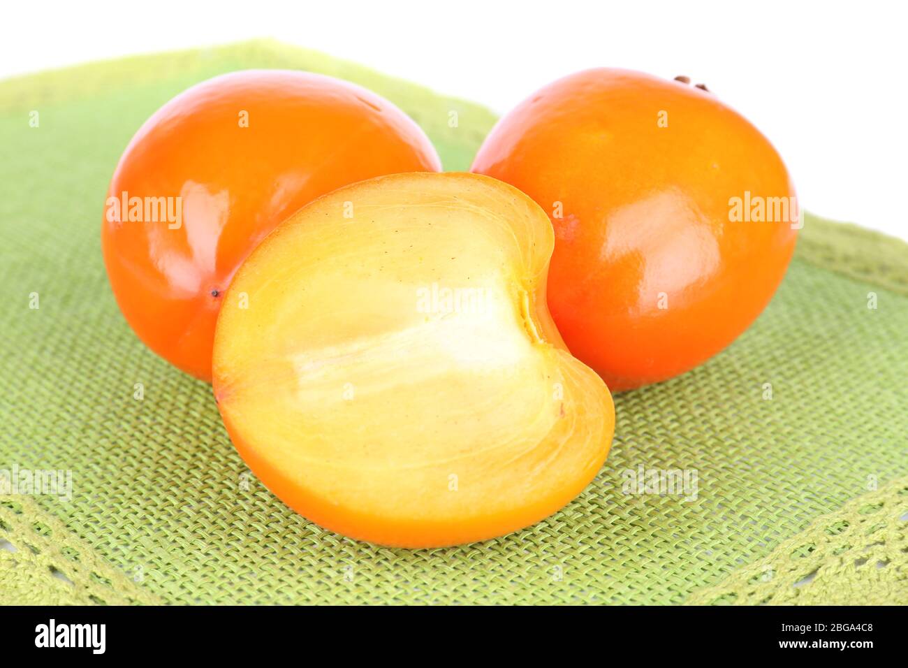 Ripe persimmons on table on white background Stock Photo - Alamy