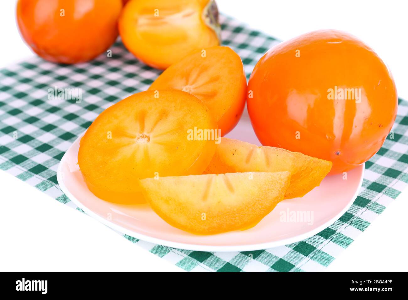 Ripe persimmons on plate close-up Stock Photo - Alamy