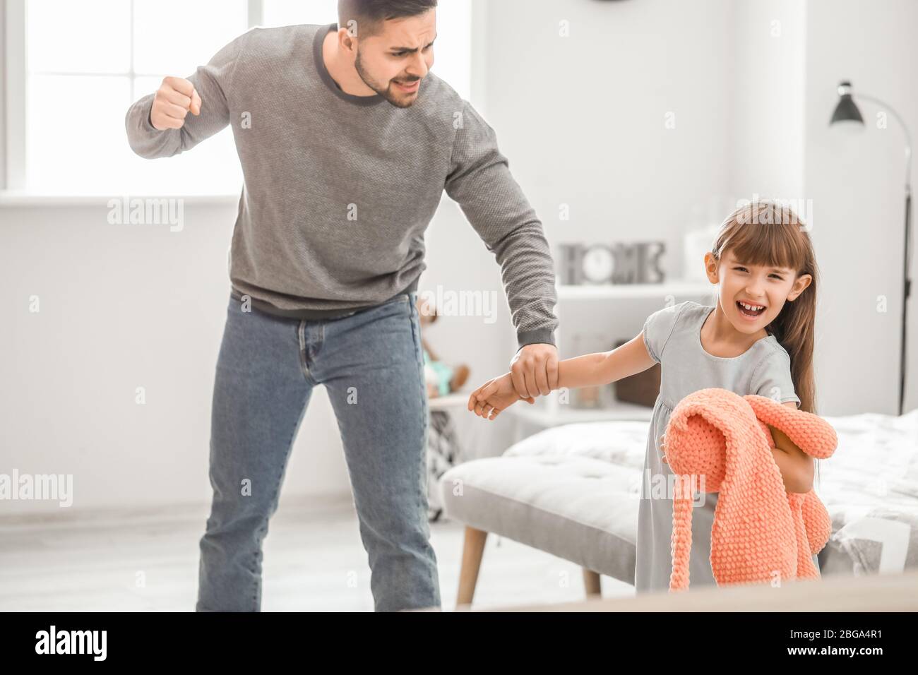 Angry father threatening his daughter at home Stock Photo - Alamy