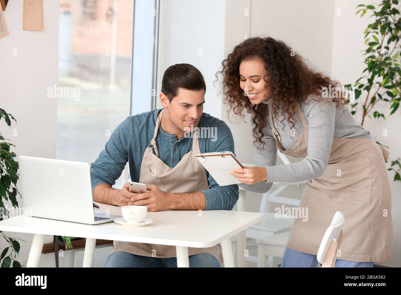 Business owners working in their cafe Stock Photo - Alamy