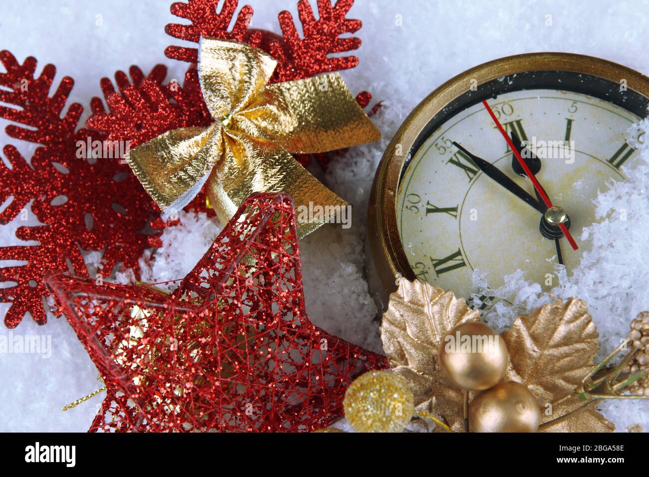 Clock and Christmas decorations under snow close up Stock Photo - Alamy