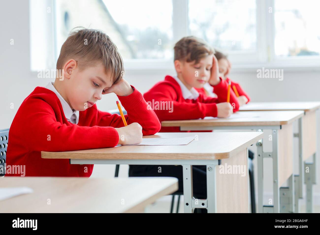 Pupils passing exam at school Stock Photo - Alamy