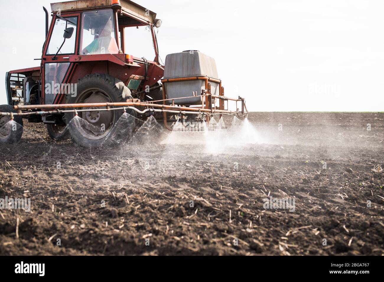 Agricultural sprayers, spray chemicals on field. spraying pesticides on ...