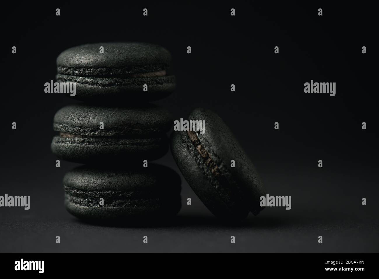 tasty and dark macarons on black with copy space Stock Photo - Alamy