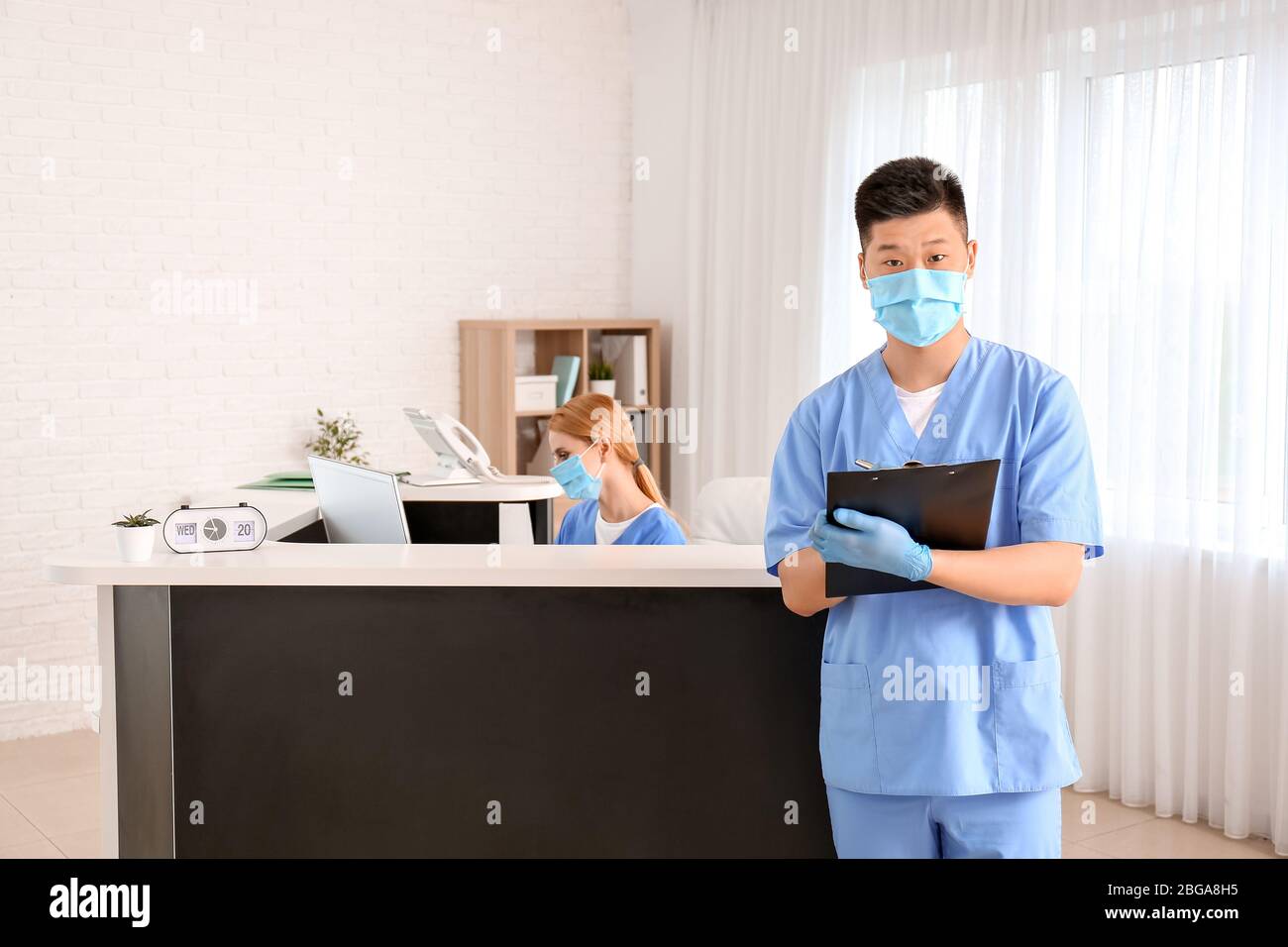 Male receptionist at desk hi-res stock photography and images - Alamy