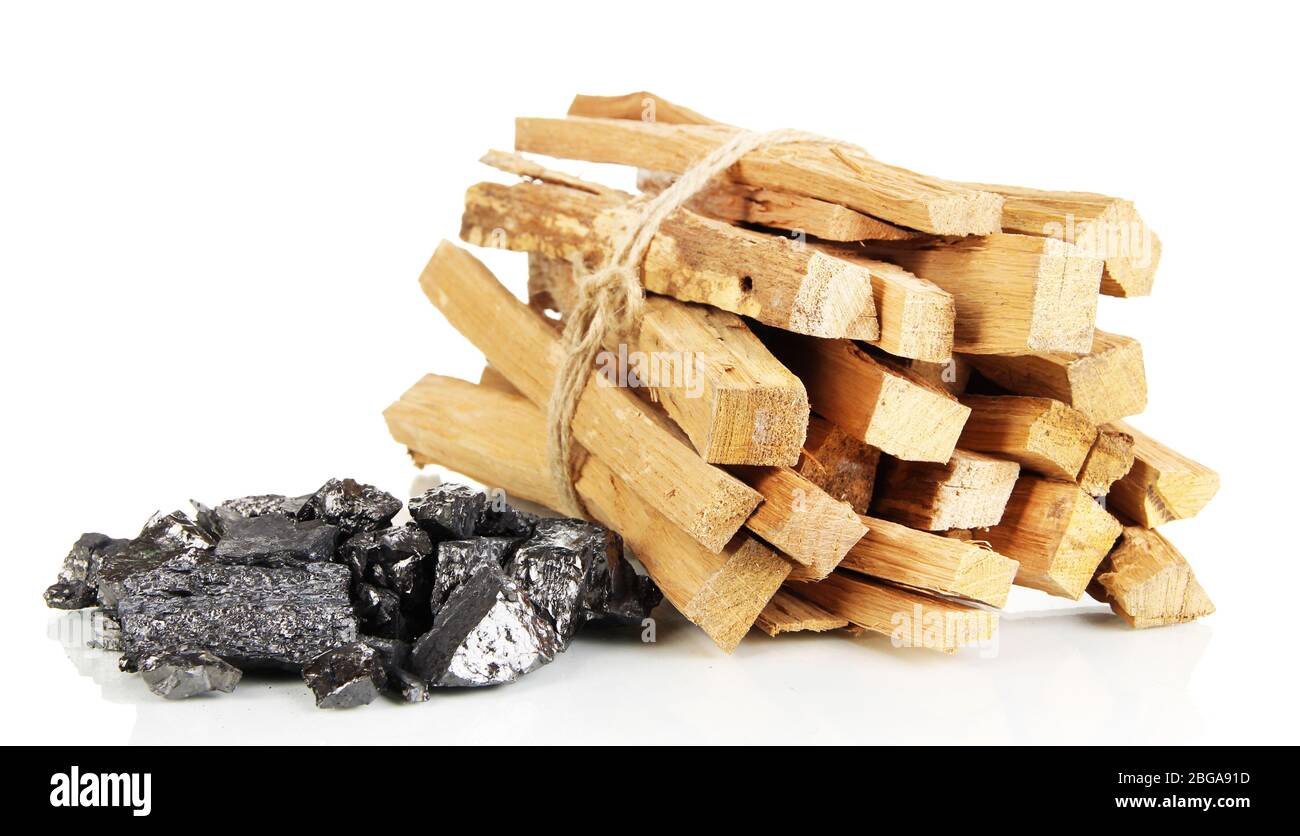 Stack of firewood and heap of coal isolated on white Stock Photo - Alamy