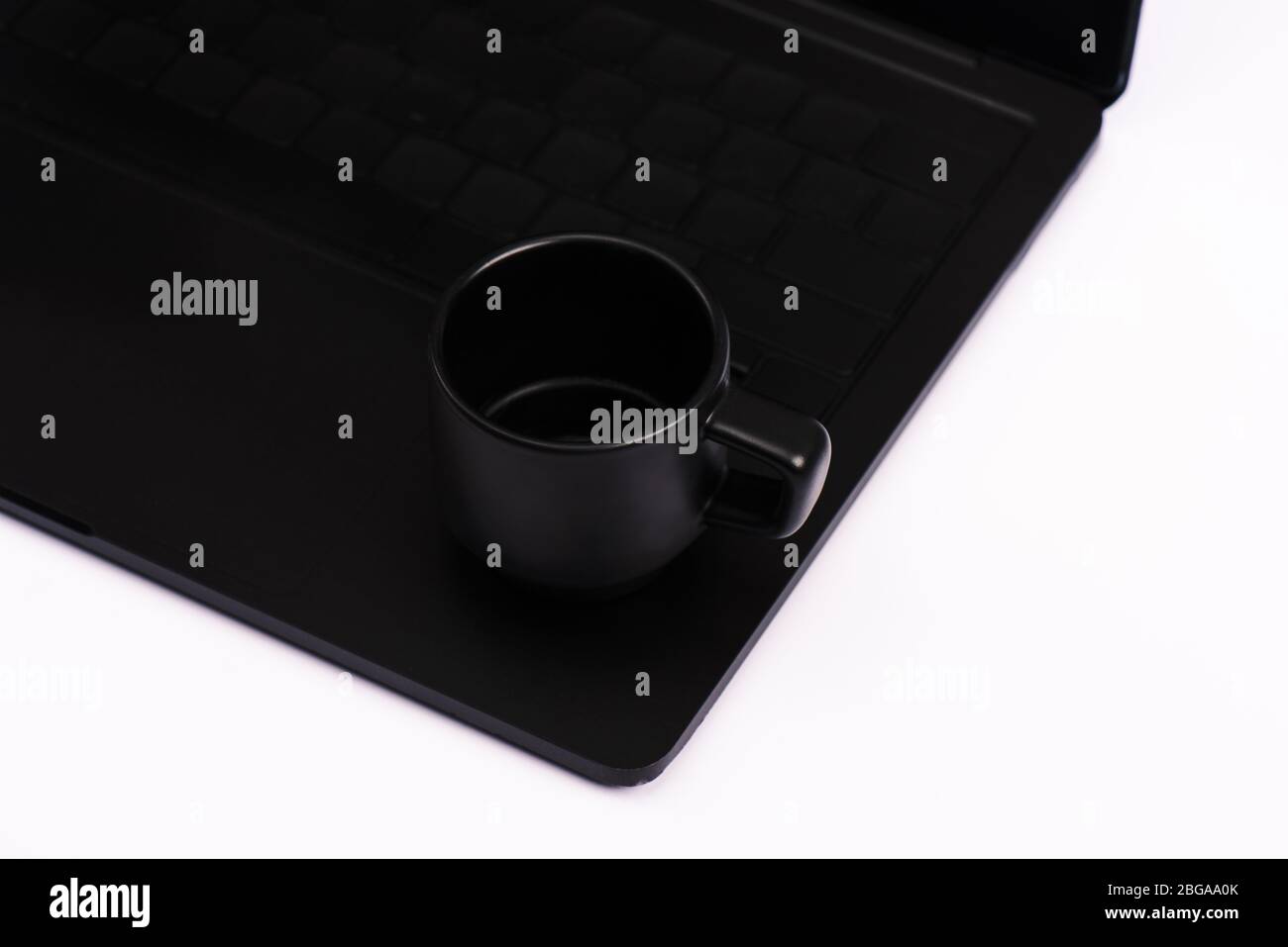 cup with drink on black laptop keyboard isolated on white Stock Photo ...