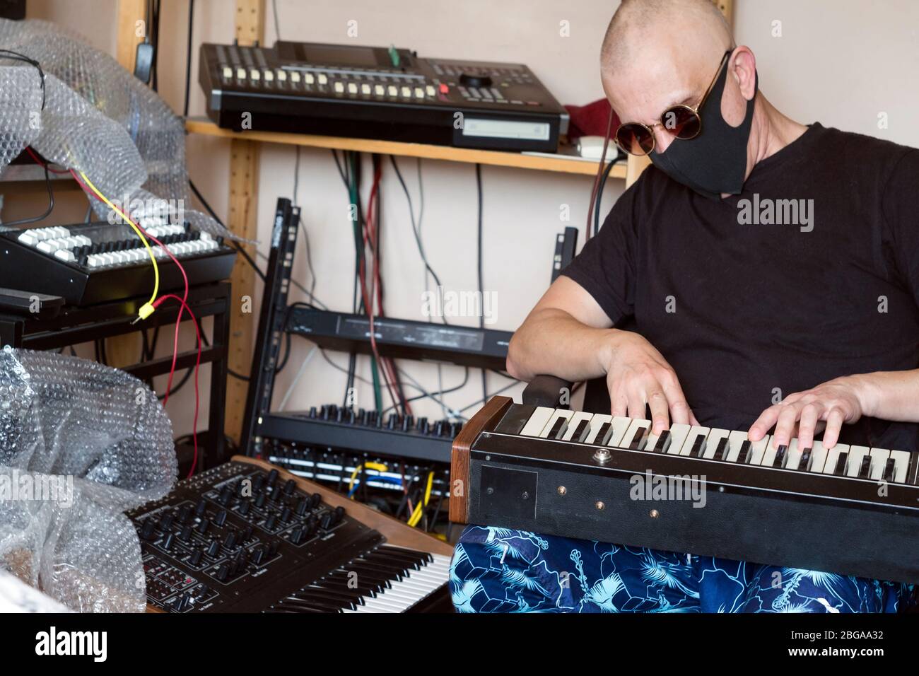 Portrait of musician in medicine mask playing keyboard, concept of ...