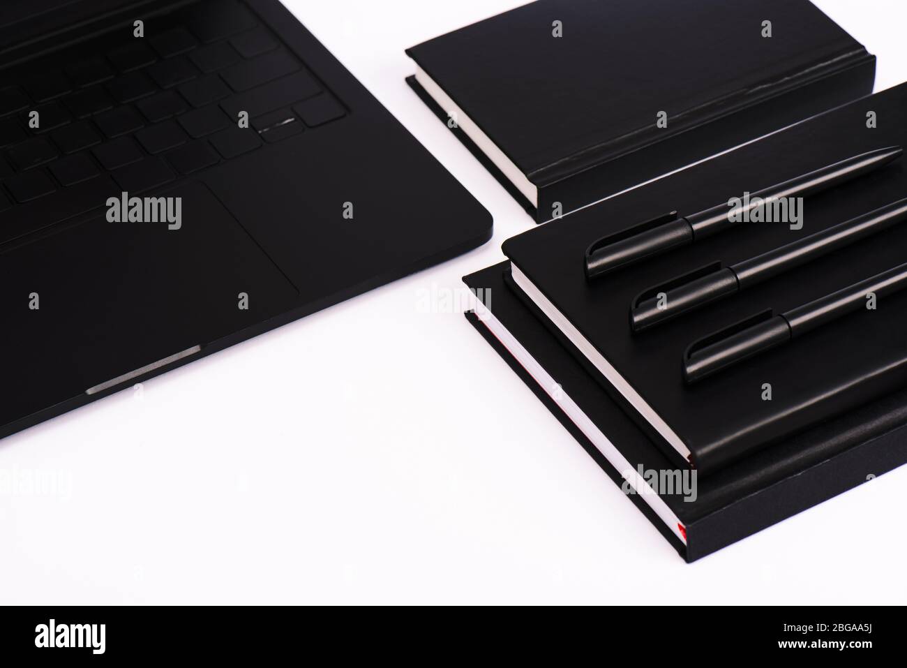 pens and notebooks near modern laptop isolated on white Stock Photo - Alamy
