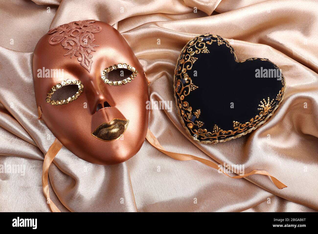 Decorative black heart and mask, on color fabric Stock Photo - Alamy