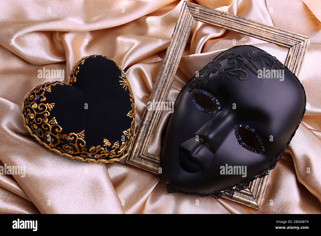 Decorative black heart and mask, on color fabric Stock Photo - Alamy