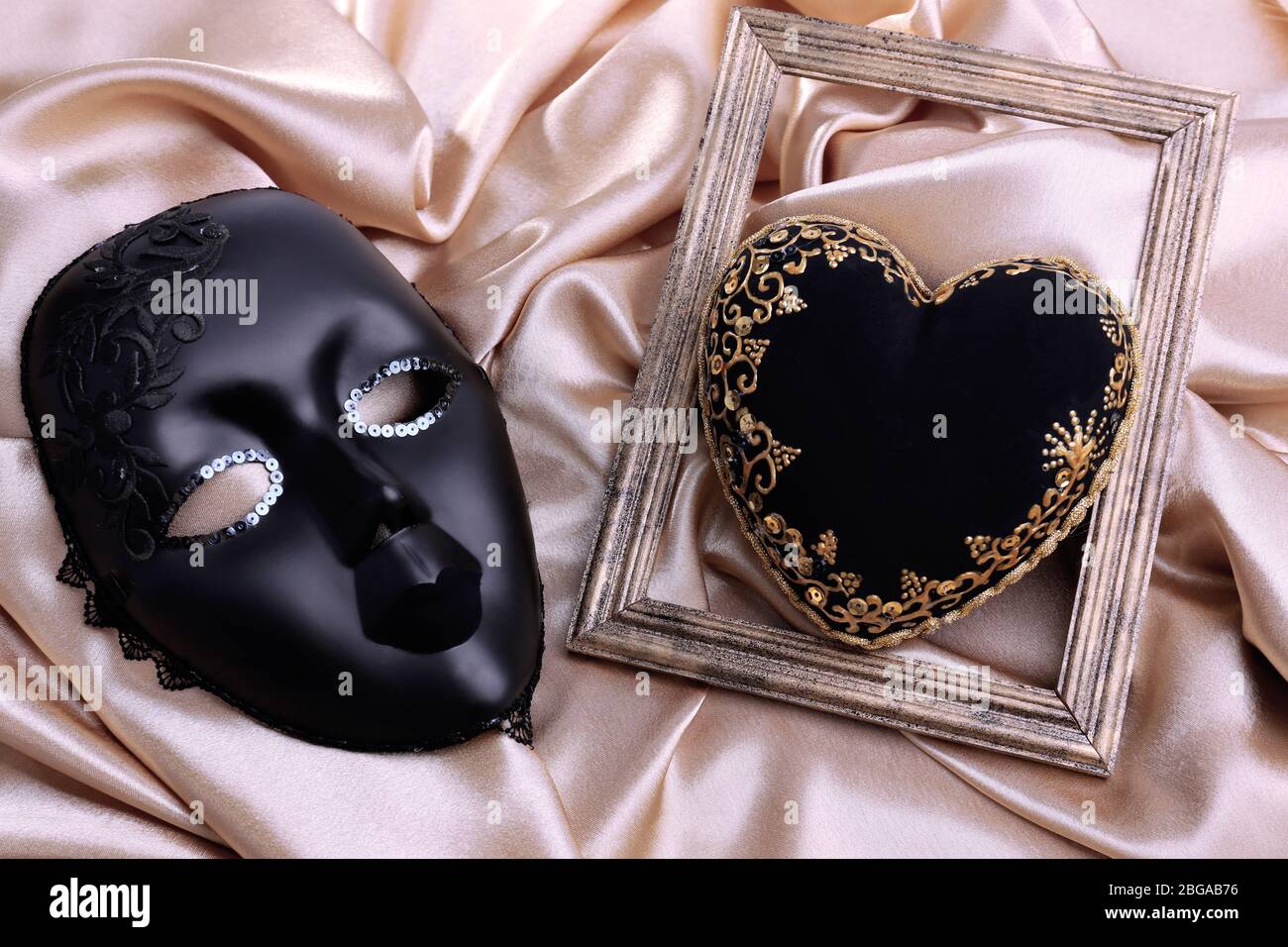 Decorative black heart and mask, on color fabric Stock Photo - Alamy