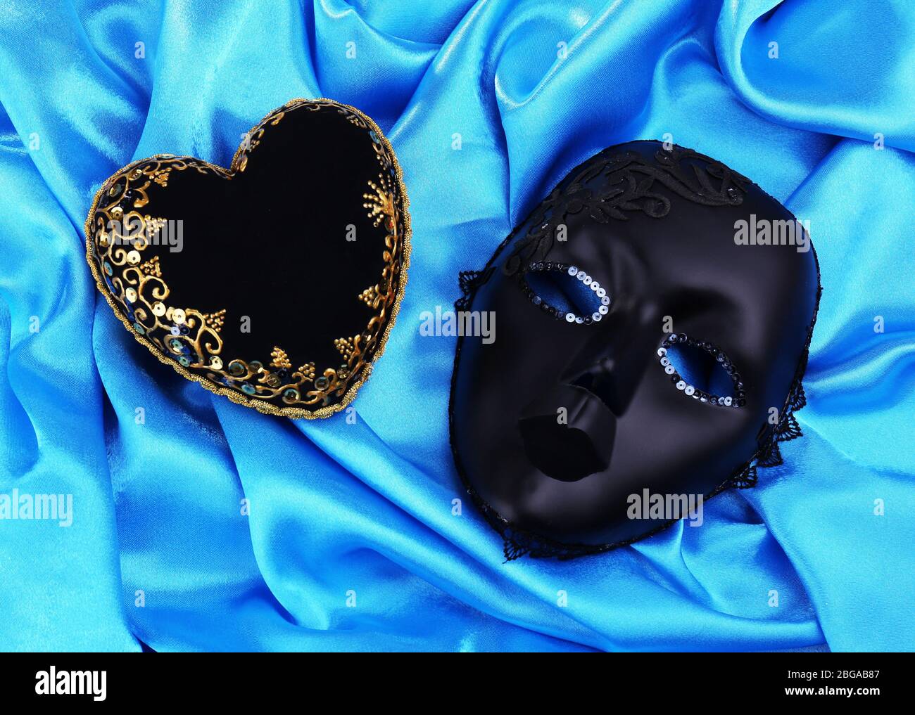 Decorative black heart and mask, on color fabric Stock Photo - Alamy