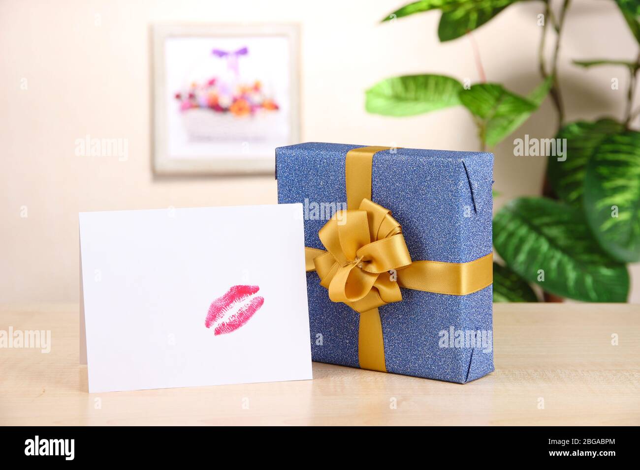Gift with card for loved one on table on room background Stock Photo ...
