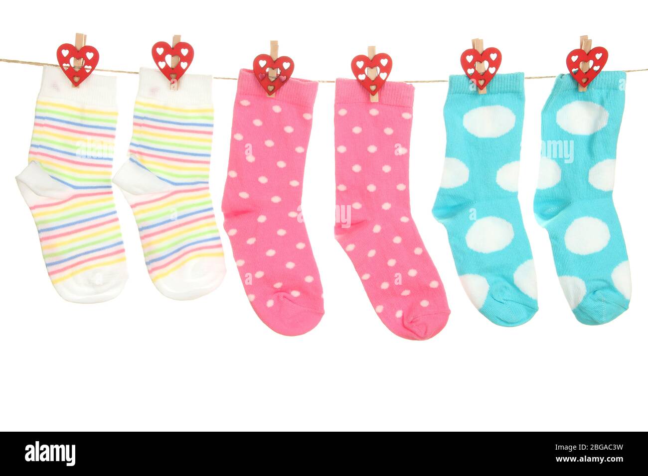Socks hanging on clothesline isolated on white Stock Photo - Alamy