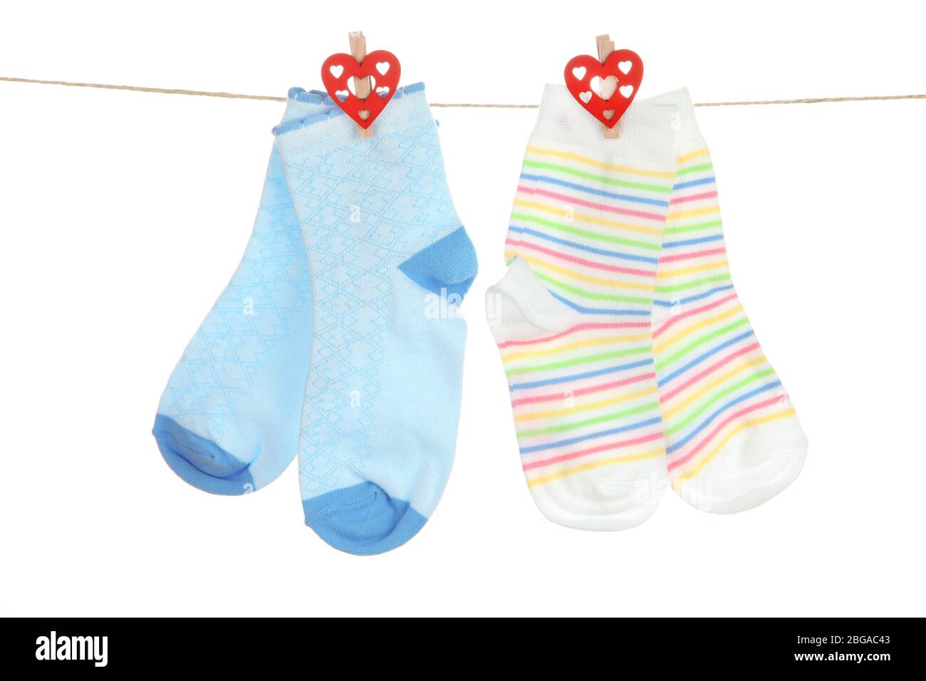 Socks hanging on clothesline isolated on white Stock Photo - Alamy