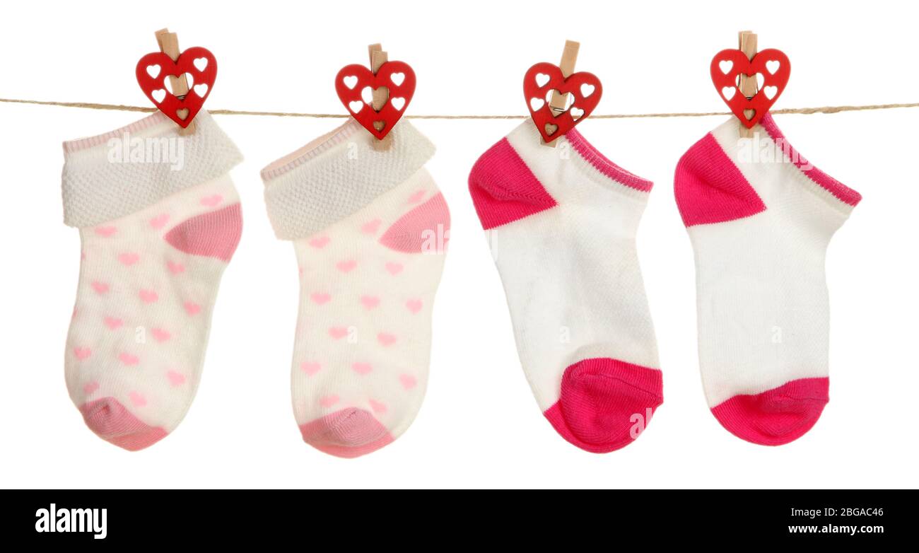 Socks hanging on clothesline isolated on white Stock Photo - Alamy