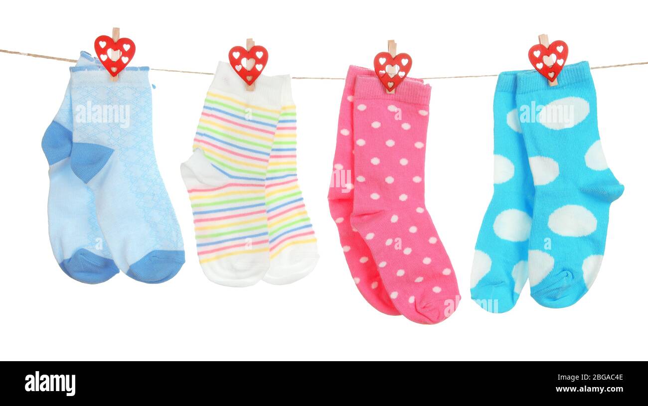 Socks hanging on clothesline isolated on white Stock Photo - Alamy