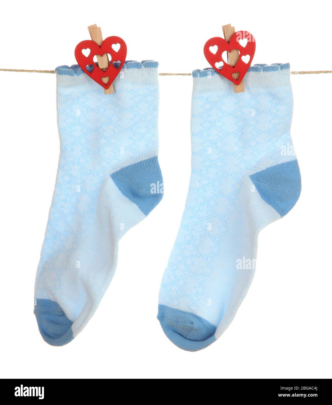 Socks hanging on clothesline isolated on white Stock Photo - Alamy