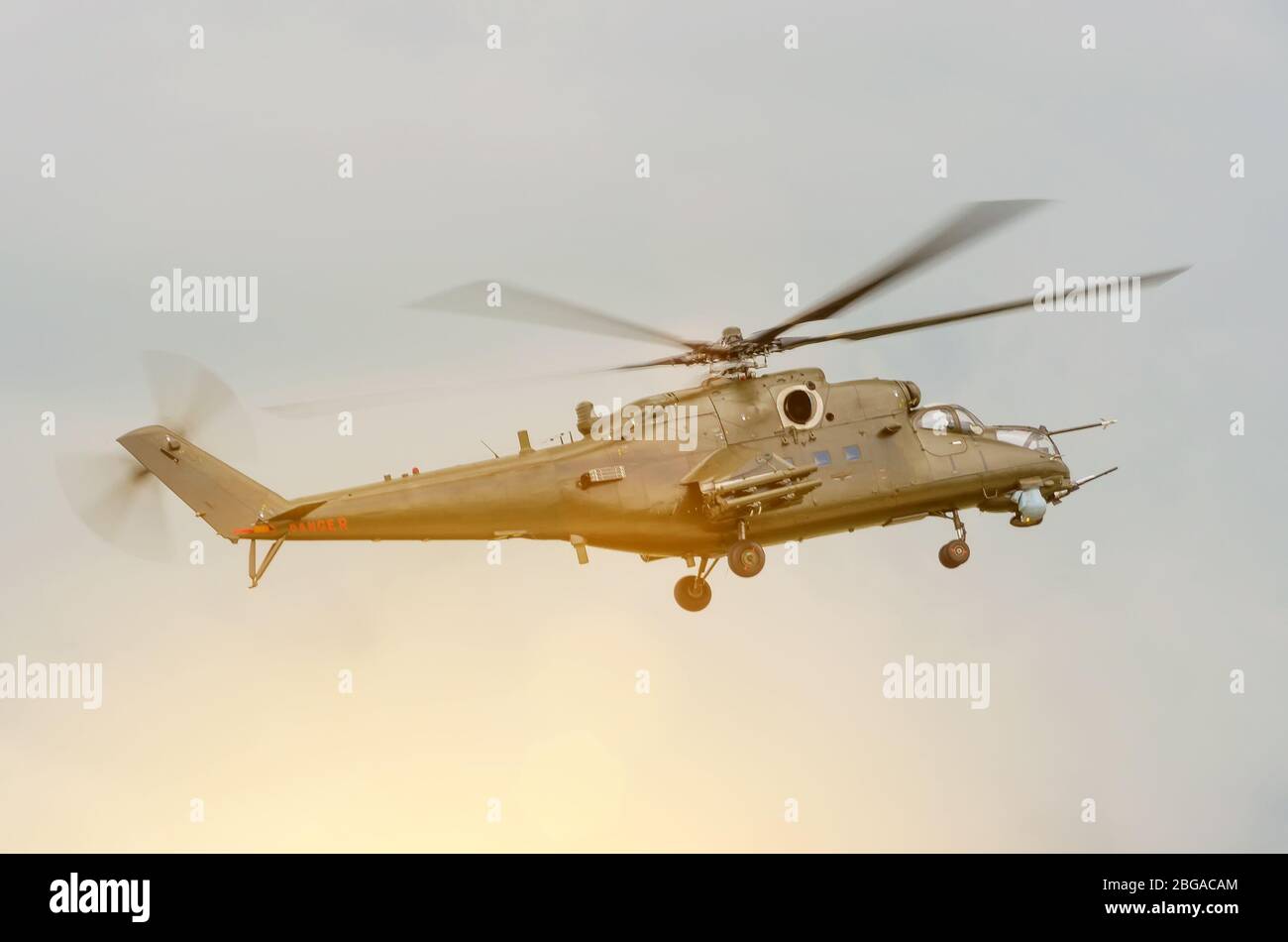 Military helicopter with weapons in the sky Stock Photo - Alamy
