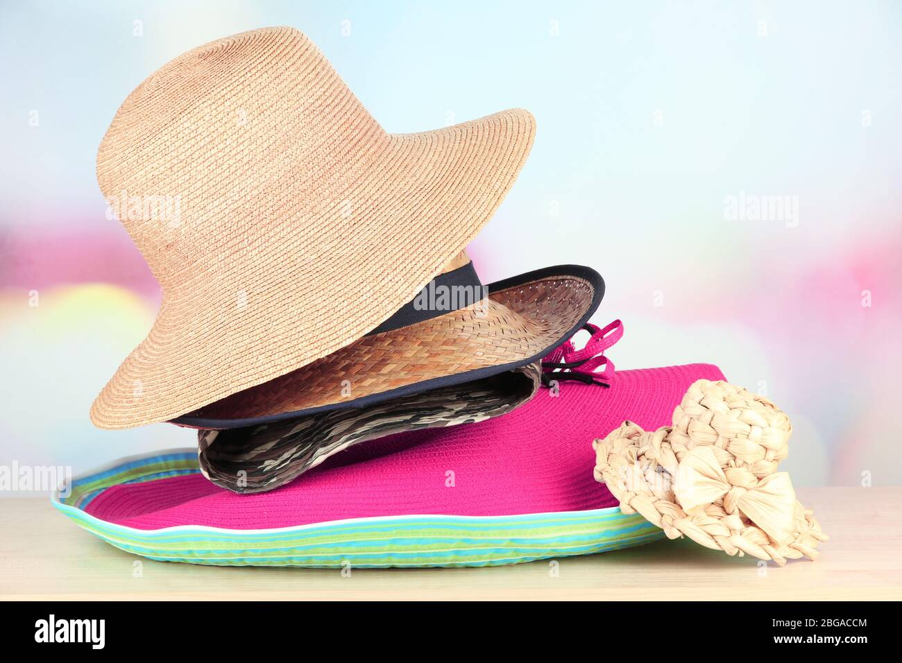 Many hats on table on light background Stock Photo - Alamy