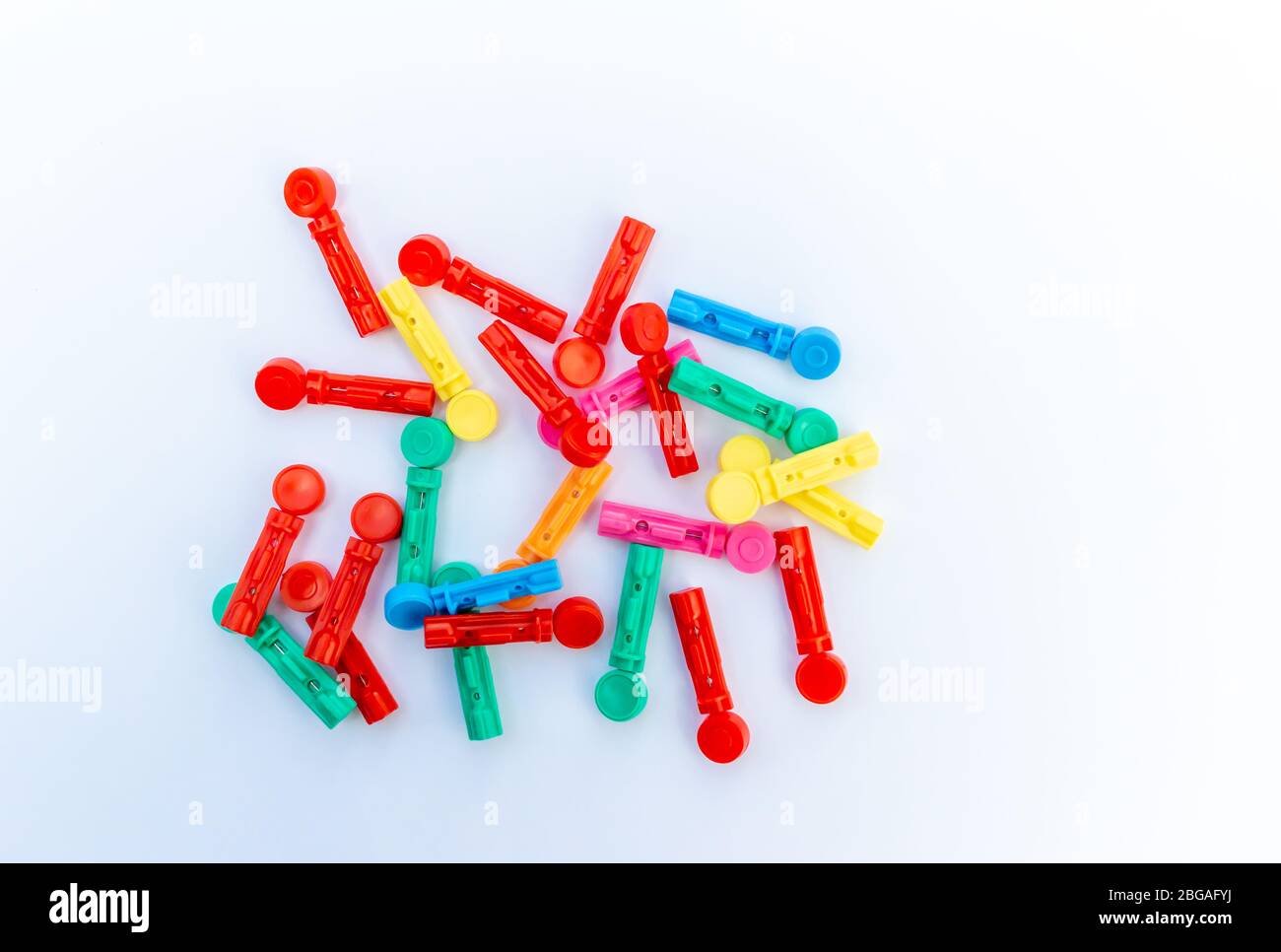 Close up abstract design of colorful glucose testing lancets on white ...