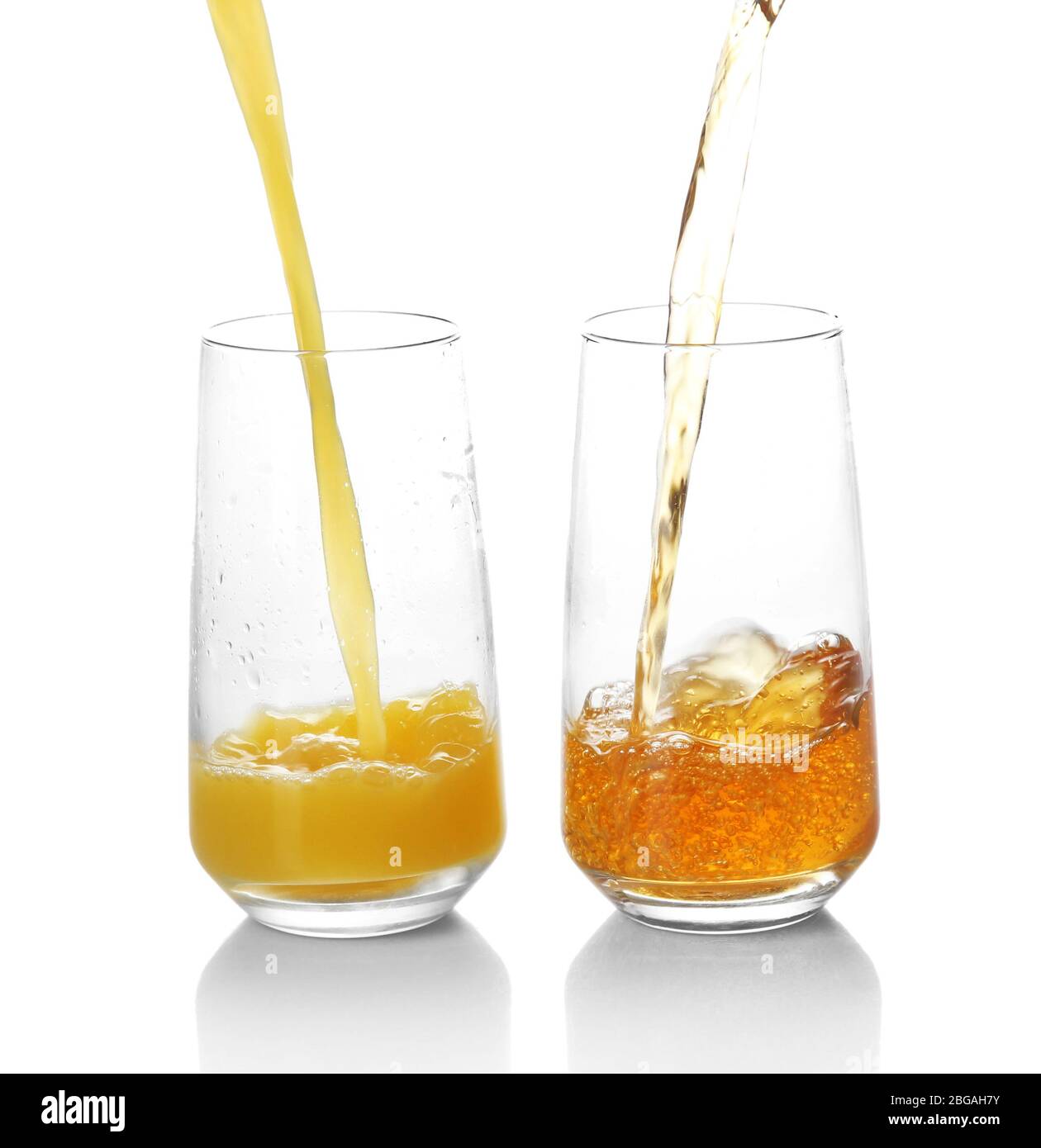 Juice pouring into glass isolated on white Stock Photo - Alamy