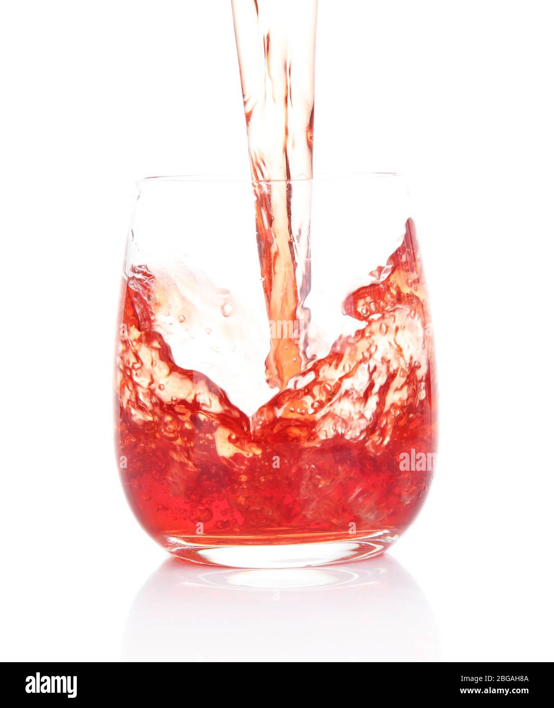 Juice pouring into glass isolated on white Stock Photo - Alamy
