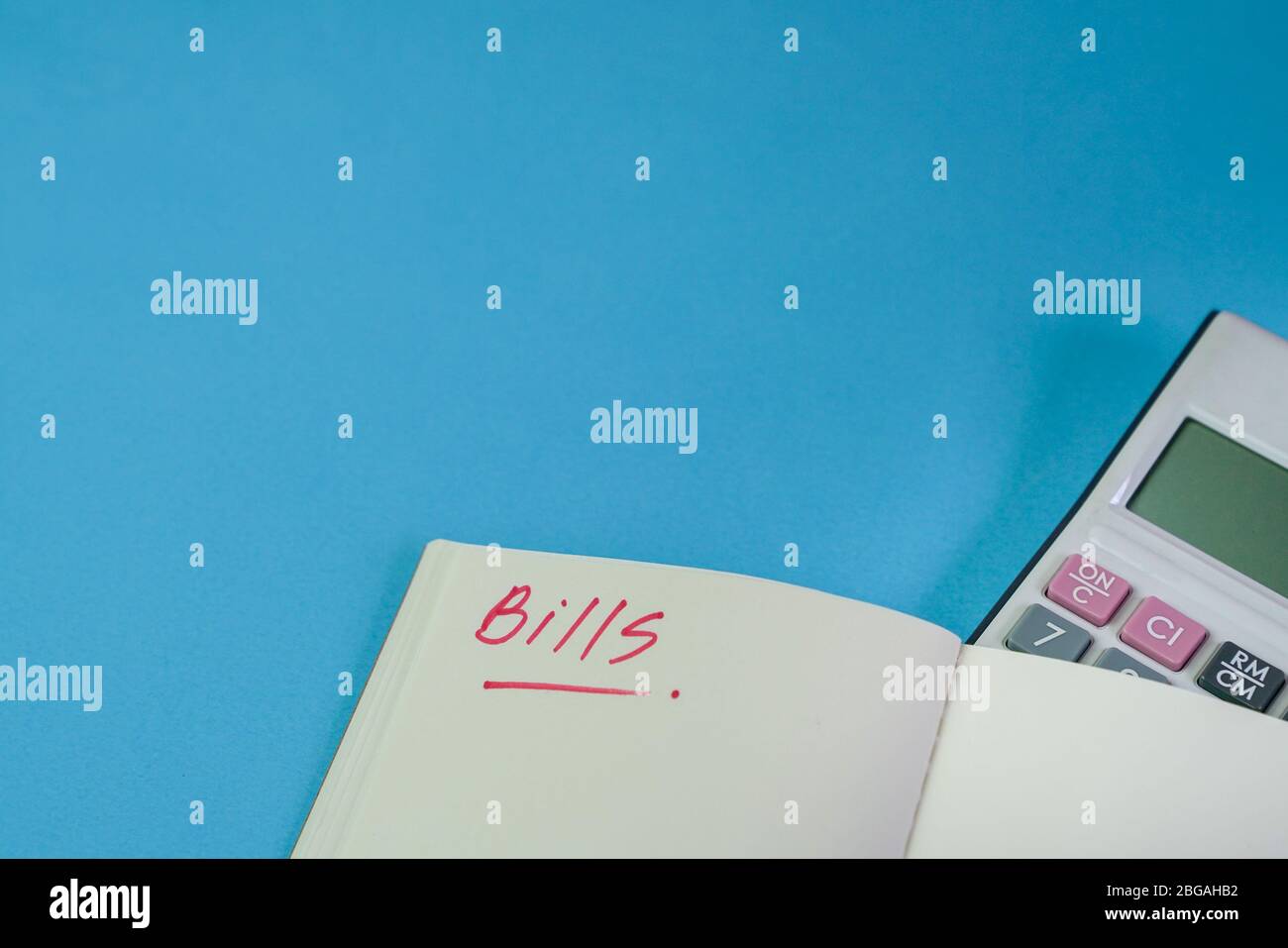Bills. Notepad with calculator on top of blue color table. Copy space ...
