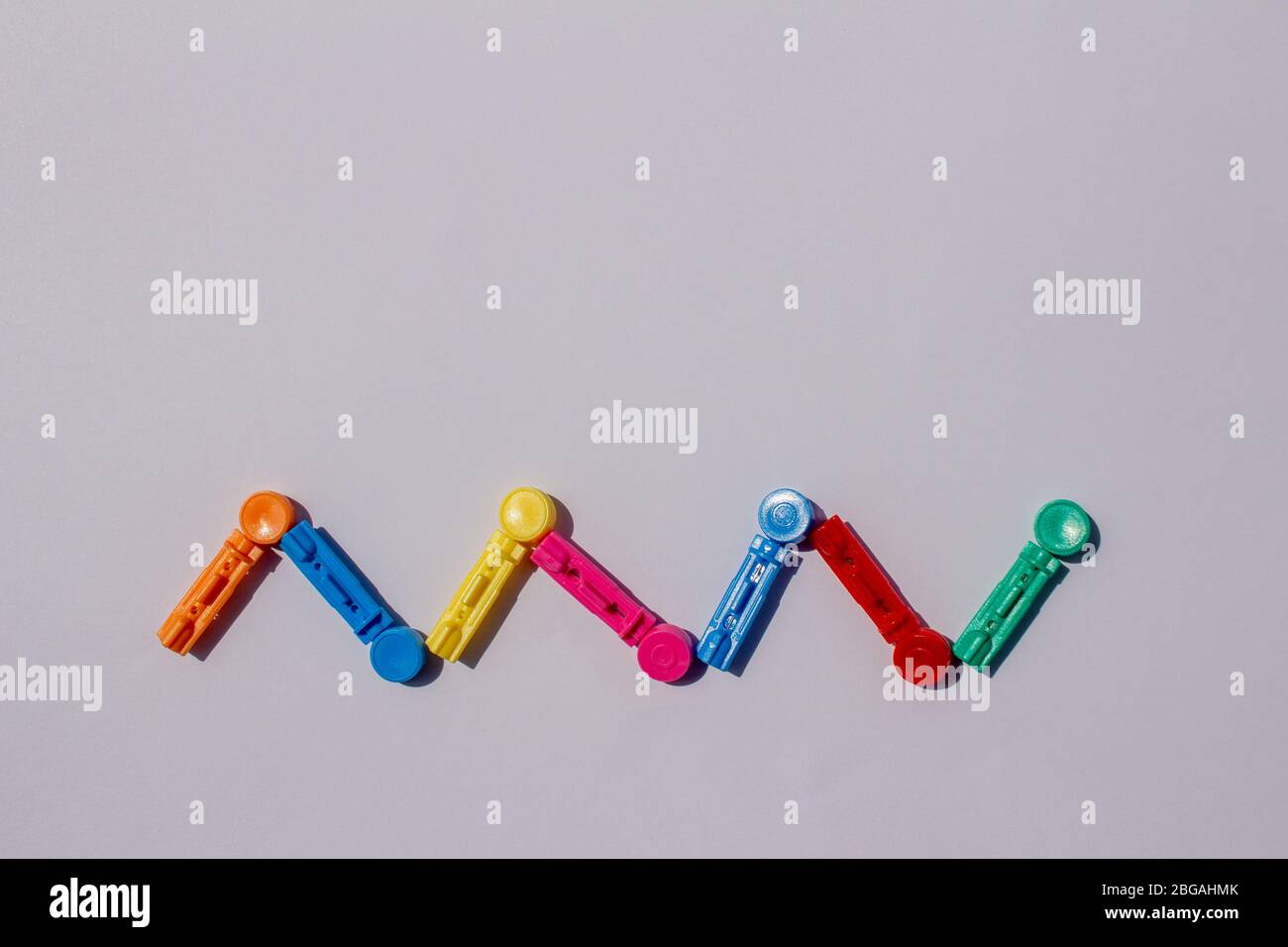 Close up abstract design of colorful glucose testing lancets on white ...