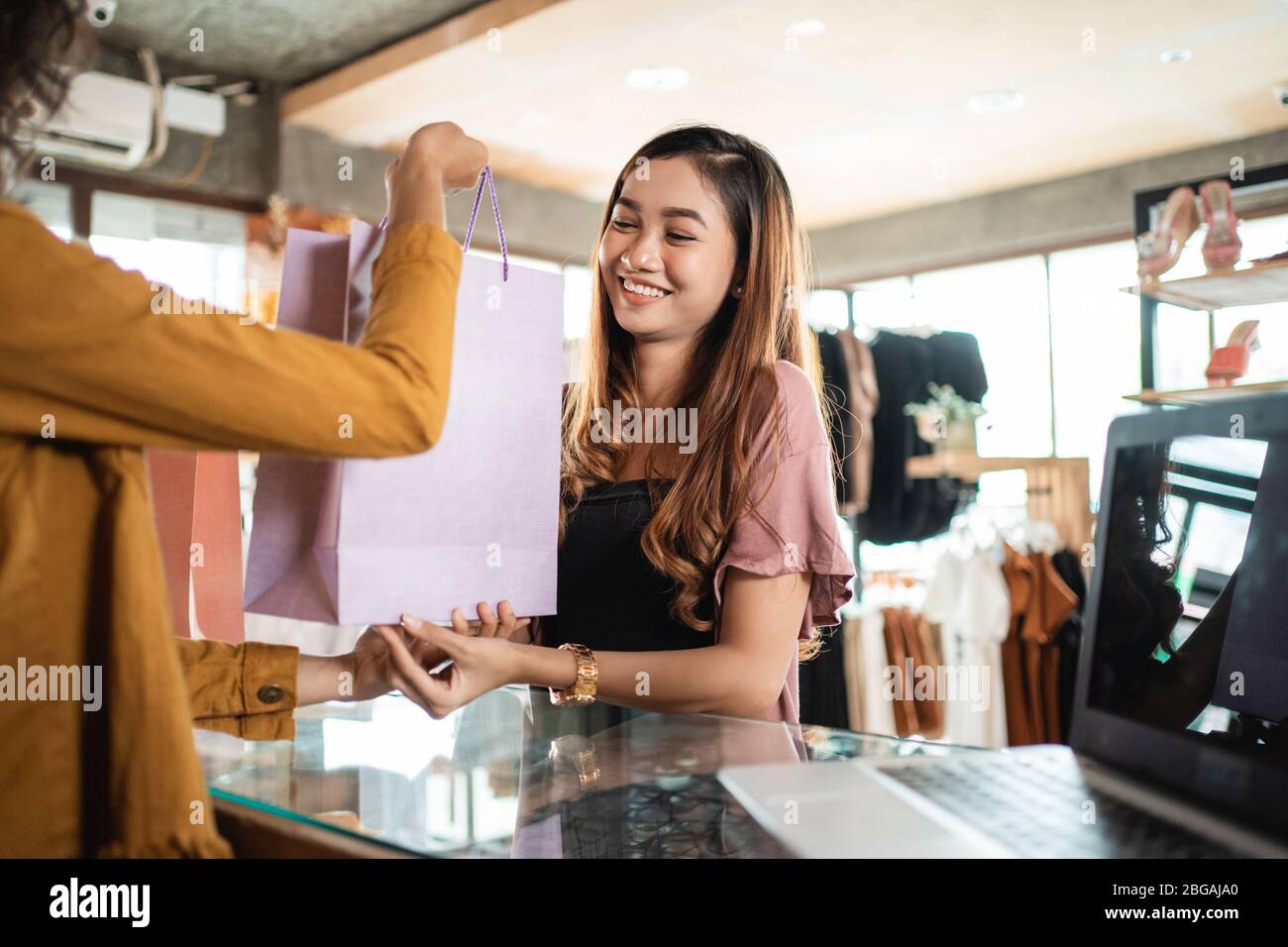 woman shopping at boutique store in the mall. shopping woman take paper ...