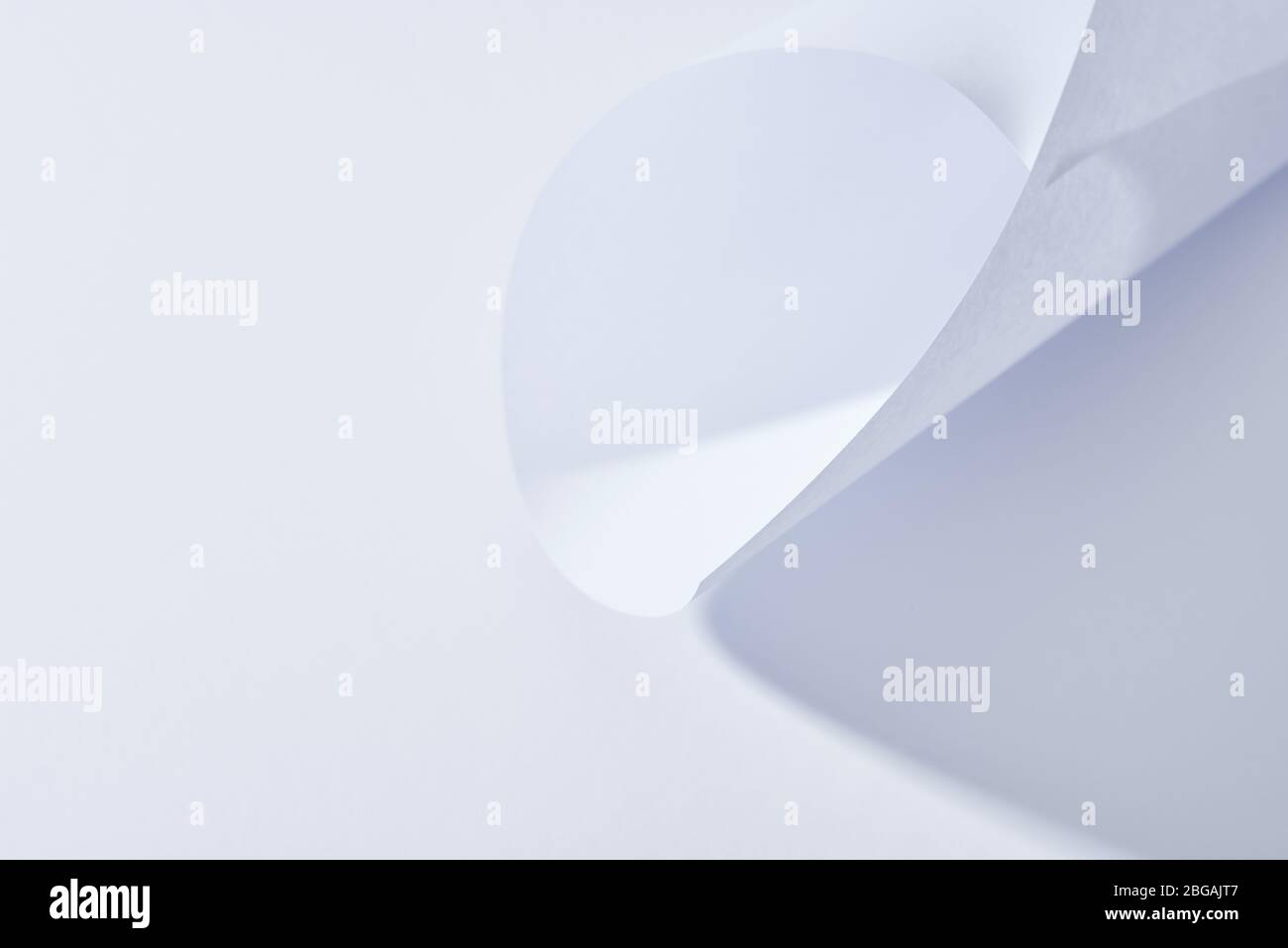 close up view of curved paper sheet on white background Stock Photo - Alamy